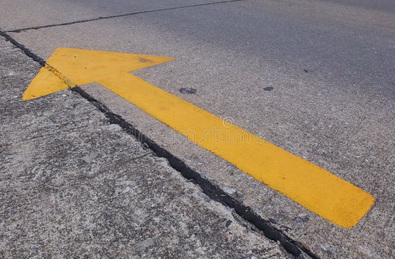 Yellow arrow on the road stock image. Image of arrow - 72998417
