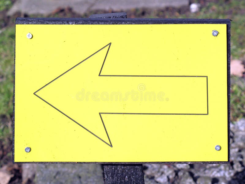 Yellow Arrow Sign Pointing this Way Left Stock Image - Image of screws ...