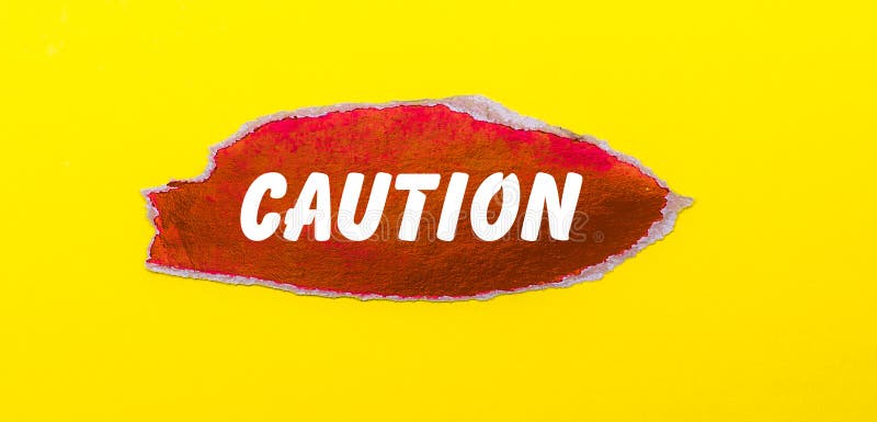 On a Yellow Background, a Sheet of Red Paper with the Word CAUTION ...