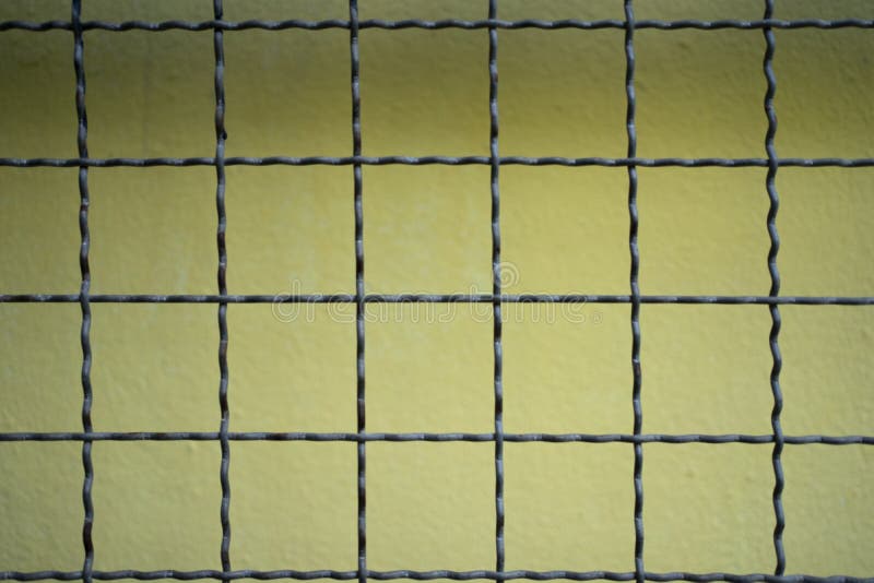 Yellow Background Steel Mesh Barrier. Stock Image - Image of grey ...