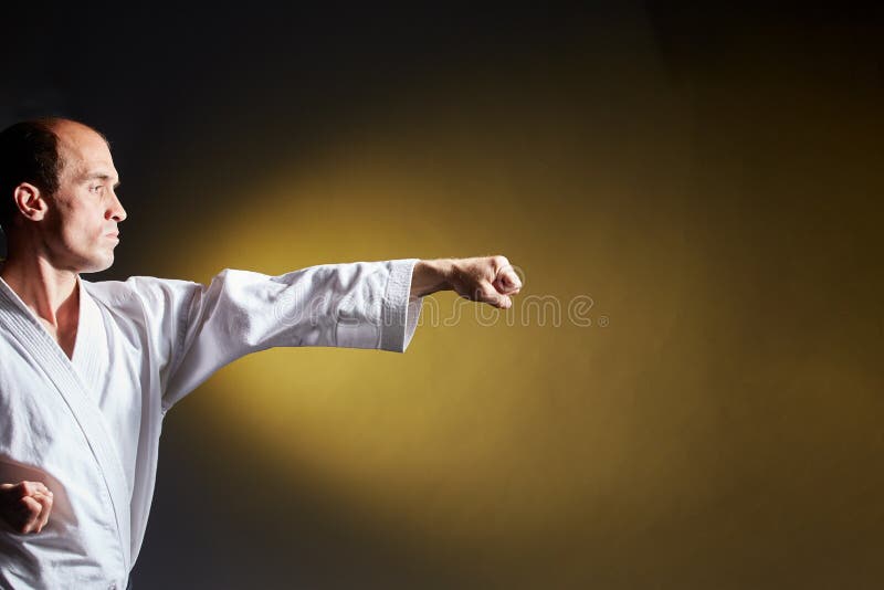 On a Yellow Background, a Young Athlete Makes a Punch Arm Stock Photo ...