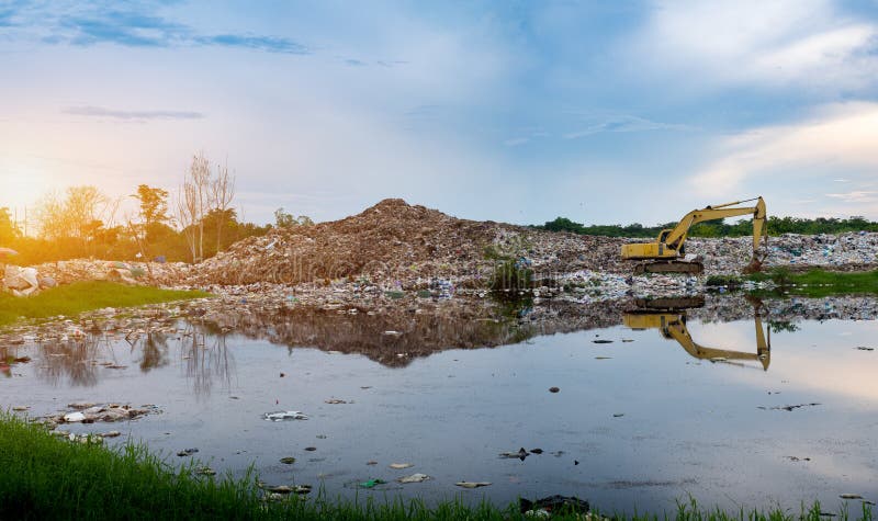 A Yellow Backhoe is Lifting Garbage at Waste Separation Plant Stock ...