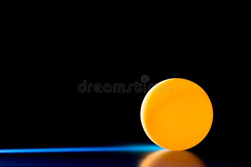 Yellow Ball on a Blue Dark Background Illuminated by a Side Beam of ...