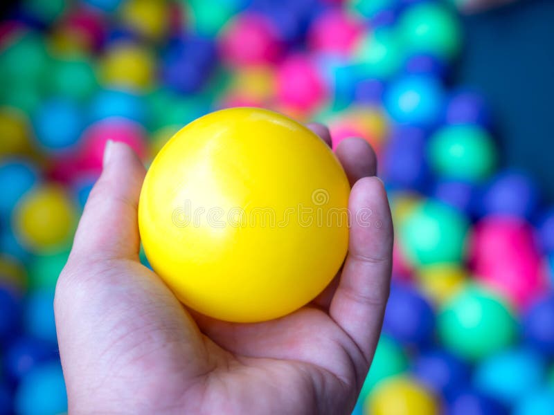 Yellow ball in men`s hand stock image. Image of color - 143167833