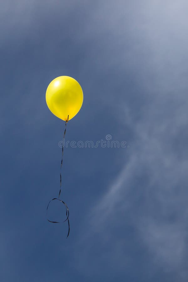 Yellow Balloon Drifting in a Clear Blue Sky Stock Image - Image of ...