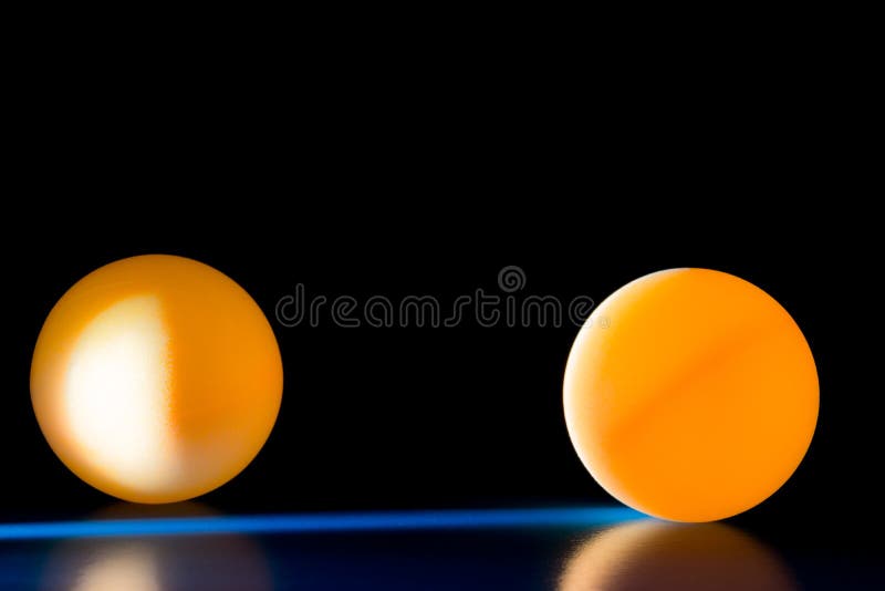 Yellow Balls on a Blue Dark Background Illuminated by a Side Beam of ...