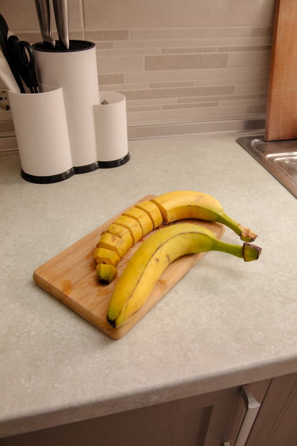 Yellow Banana on a Kitchen Table Cut into Pieces Stock Image - Image of ...