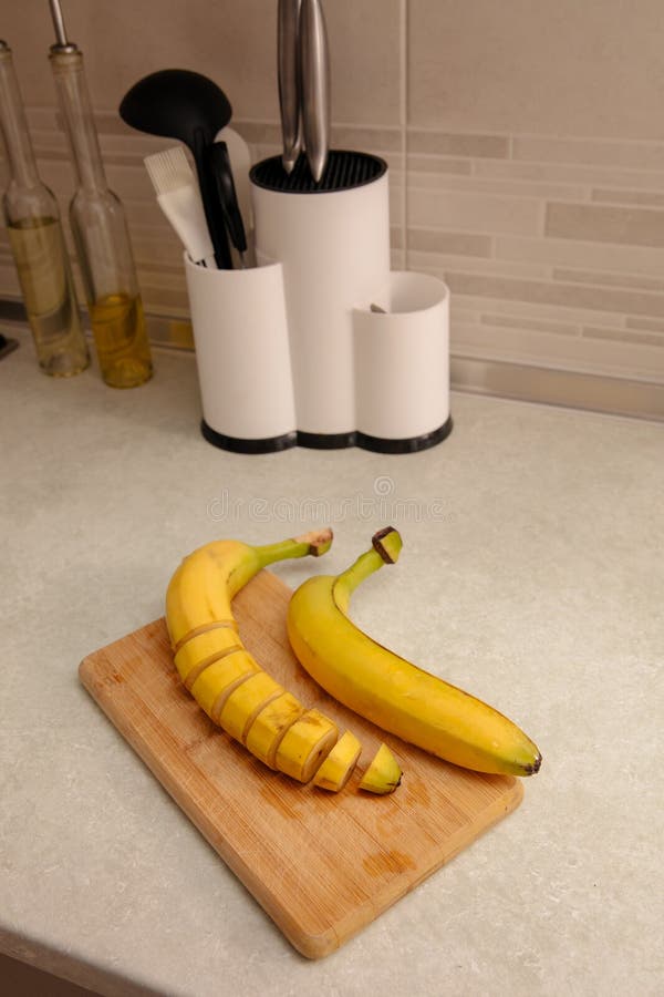 Yellow Banana on a Kitchen Table Cut into Pieces Stock Image - Image of ...