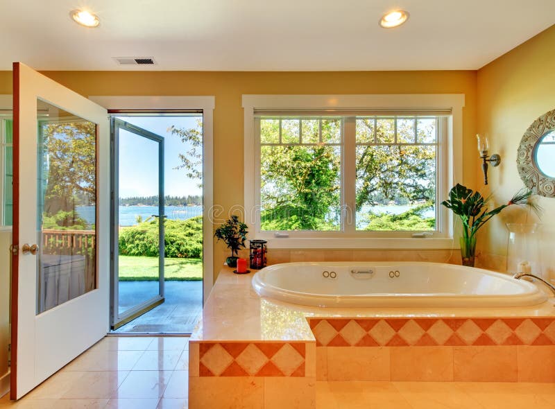 Yellow Bathroom with Lake View and Large Tub. Stock Image - Image of ...