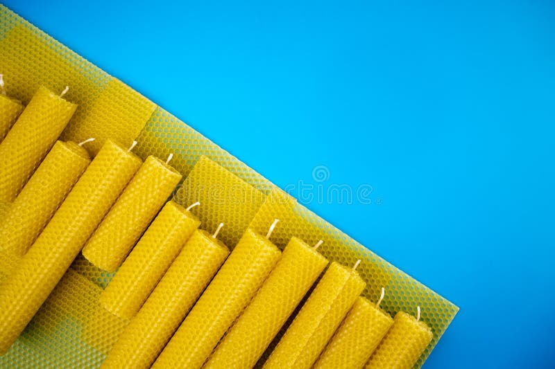 Yellow Beeswax Candles on Blue Background Top View Stock Photo - Image ...