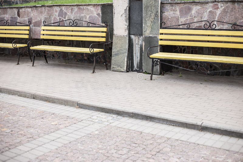Yellow bench in the park stock photo. Image of comfortable - 127673388
