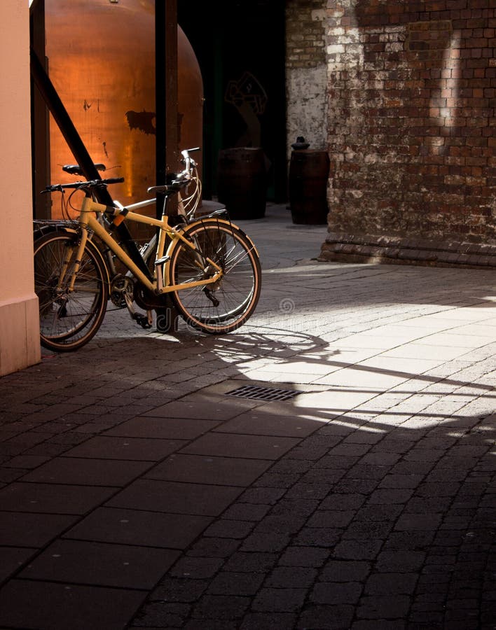 Yellow Bicycle in City with Dramatic Shadows Stock Image - Image of ...