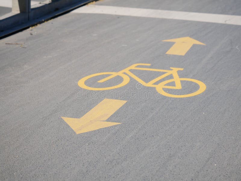 Yellow Bicycle Sign with Arrows on the Asphalt Stock Photo - Image of ...