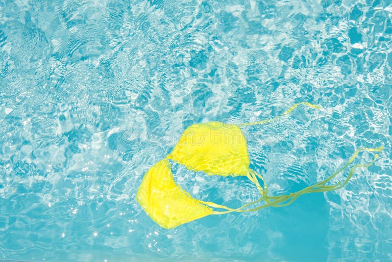Yellow Bikini in Clean Blue Water of the Pool. Vertical Size. Stock ...