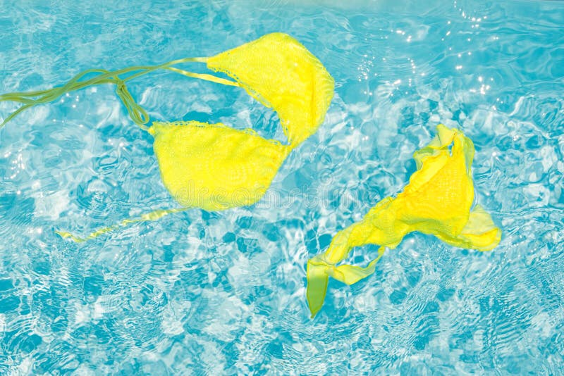 Yellow Bikini in Clean Blue Water of the Pool. Vertical Size. Stock ...