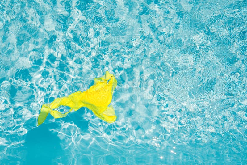 Yellow Bikini in Clean Blue Water of the Pool. Vertical Size. Stock ...