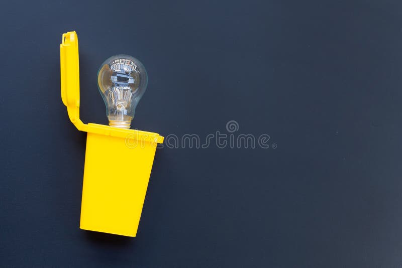 Yellow Bin with Light Bulb on Dark Background. Ideas and Creative ...