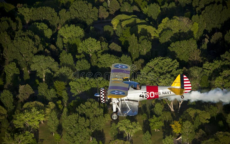 Yellow biplane over trees stock photo. Image of army, aviation - 9452788