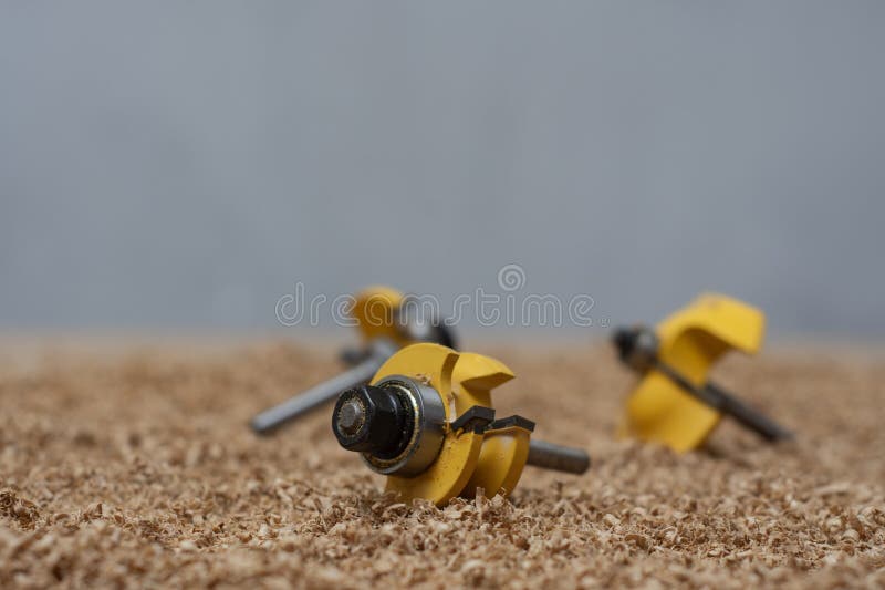Yellow Bits for Router Saw on a Sawdust Covered Surface. Tools for ...