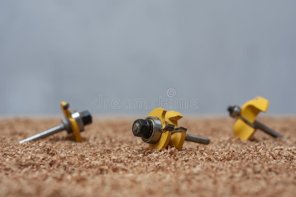 Yellow Bits for Router Saw on a Sawdust Covered Surface. Tools for ...