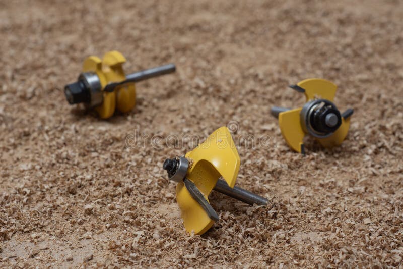 Yellow Bits for Router Saw on a Sawdust Covered Surface. Tools for ...