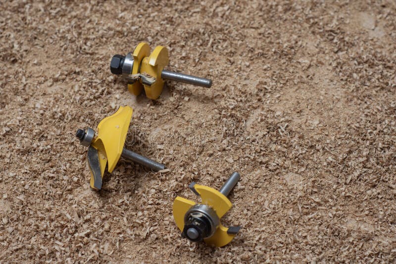 Yellow Bits for Router Saw on a Sawdust Covered Surface. Tools for ...