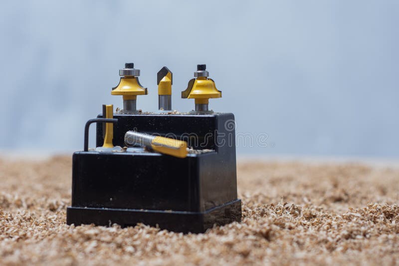 Yellow Bits for Router Saw on a Sawdust Covered Surface. Tools for ...