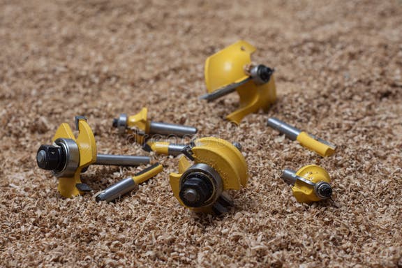 Yellow Bits for Router Saw on a Sawdust Covered Surface. Tools for ...