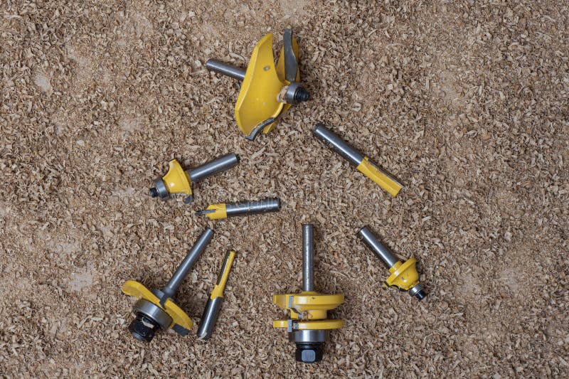 Yellow Bits for Router Saw on a Sawdust Covered Surface. Tools for ...