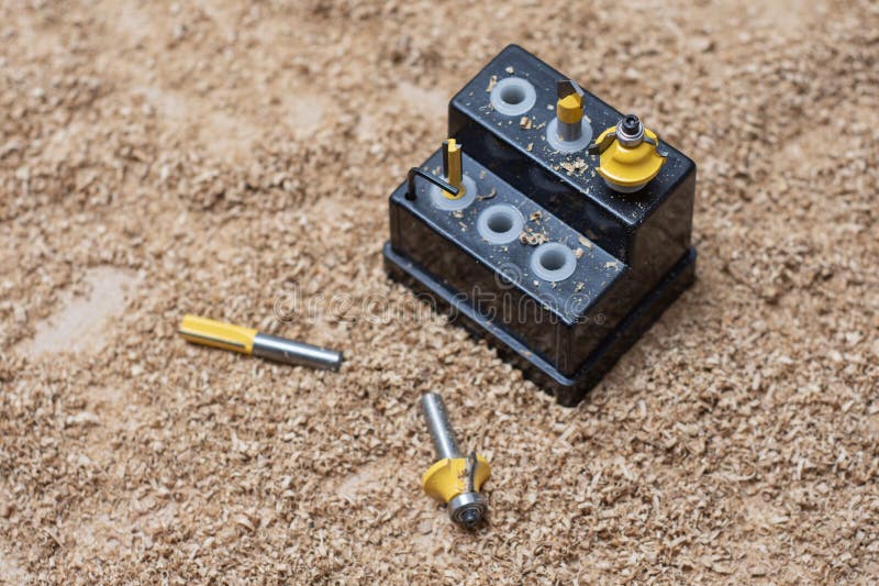 Yellow Bits for Router Saw on a Sawdust Covered Surface. Tools for ...