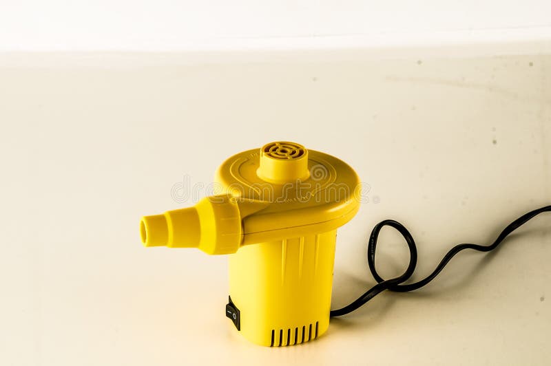 A Yellow and Black Air Compressor Sits on a White Surface Stock Photo ...