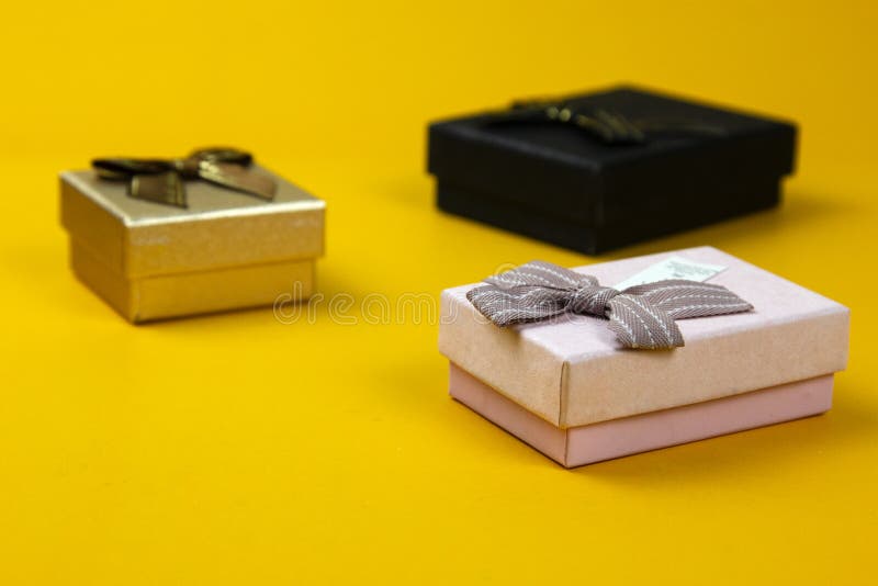 Yellow and Black Gift Box with Ribbons, Three Gift Boxes on the Yellow ...