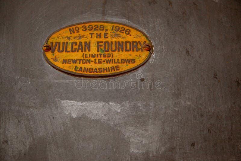 A Yellow and Black Label with the Word Vulcan on it Stock Photo - Image ...