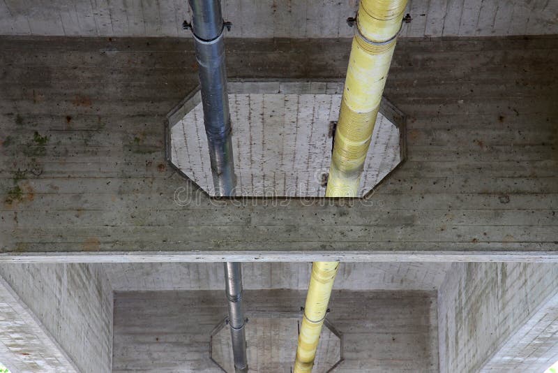 Yellow and Black Pipe Attached Under a Concrete Bridge Stock Image ...