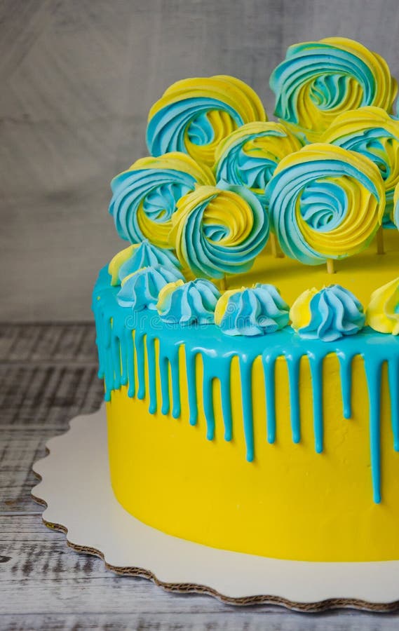 Yellow and Blue Cream Cheese Color Drip Cake with Merengues Stock Photo ...