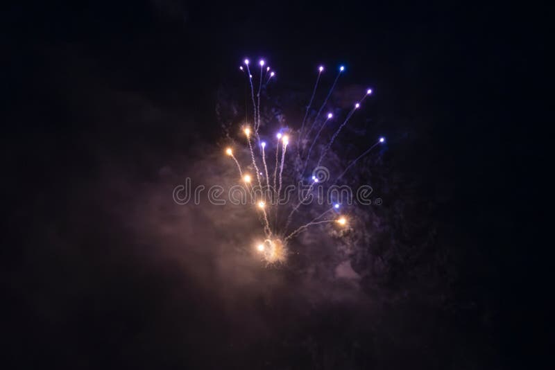 Yellow and blue firework stock photo. Image of smoke - 327043664