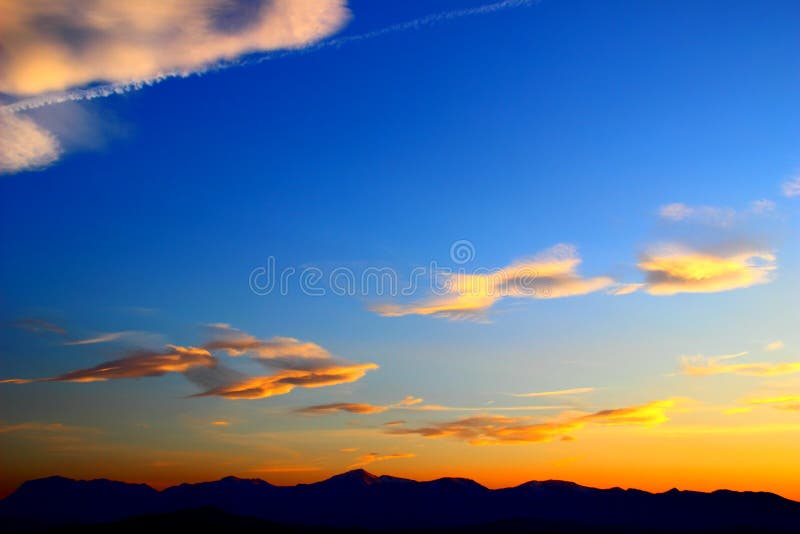 Yellow-blue Sunset Sky with Clouds Over the Silhouettes of the ...