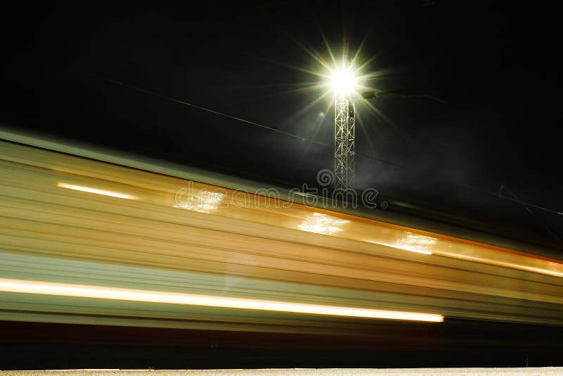 Yellow and Blue Train with Lights Passing by in the Night. Stock Image ...