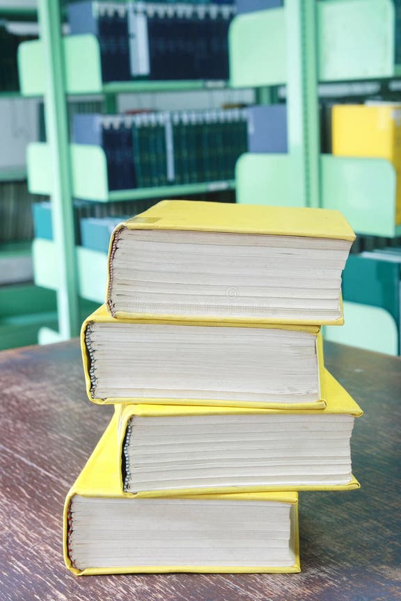 Yellow book stack on table stock photo. Image of bible - 35085962