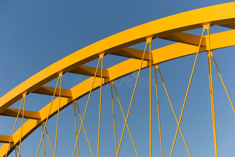 Yellow Steel Arch of a Bridge Against a Steel Blue Sky Stock Image ...