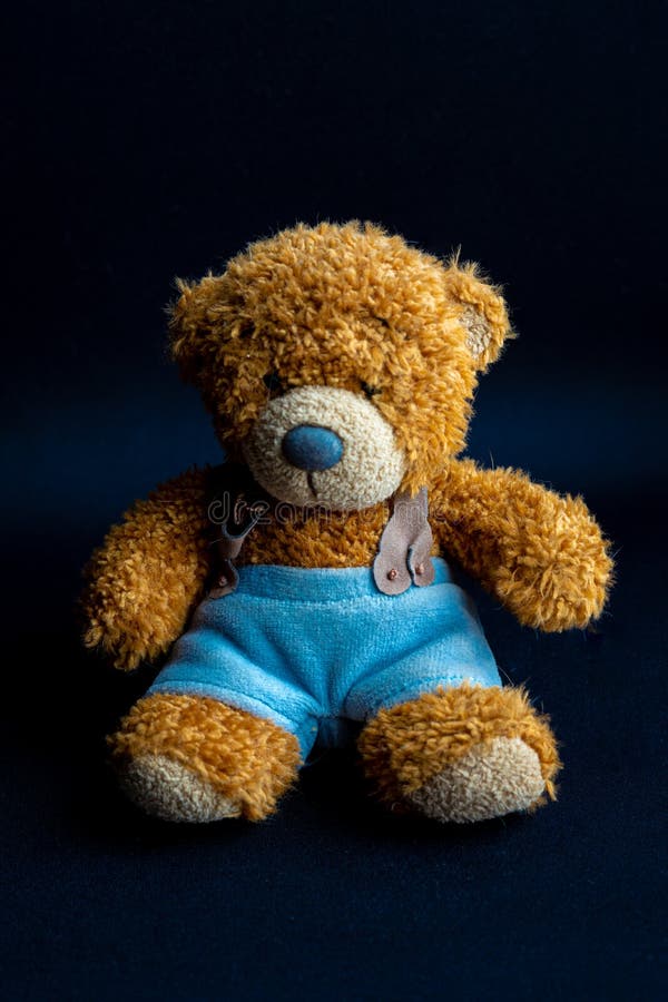Yellow Brown Small Teddy Bear in Blue Pants is Sitting Stock Photo ...