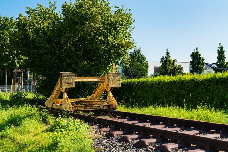 A Yellow Buffer Stop at the End of a Railway Track Stock Image - Image ...