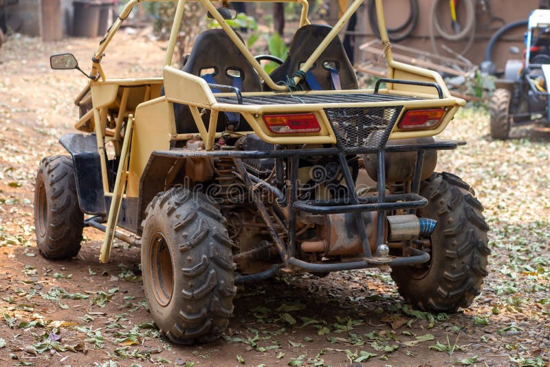 A yellow buggy is parked stock image. Image of background - 241241281