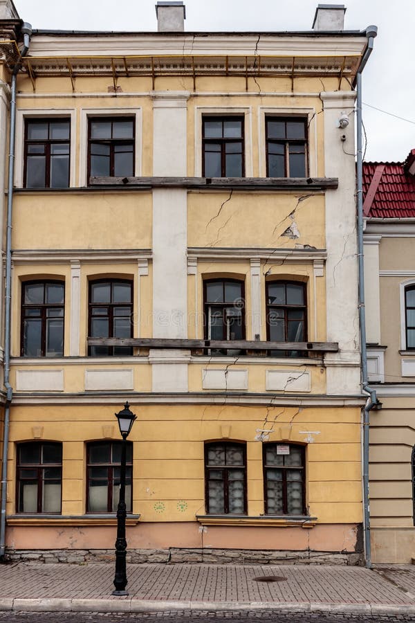 A Yellow Building with a Black Lamp Post in Front of it Stock Photo ...
