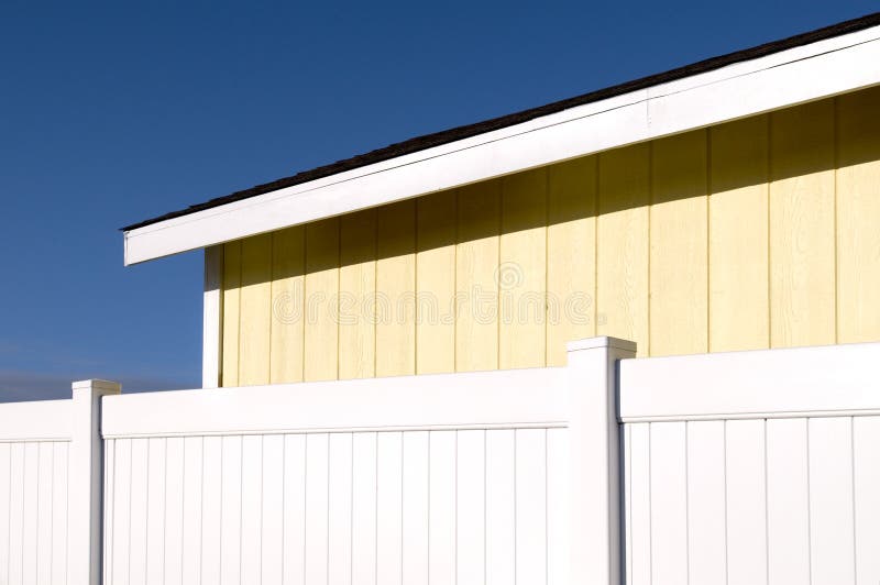Yellow Building and White Fence Stock Image - Image of siding, home ...