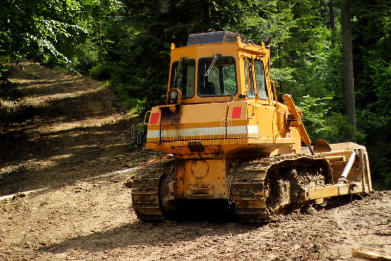 Yellow bulldozer in forest stock image. Image of track - 31086171