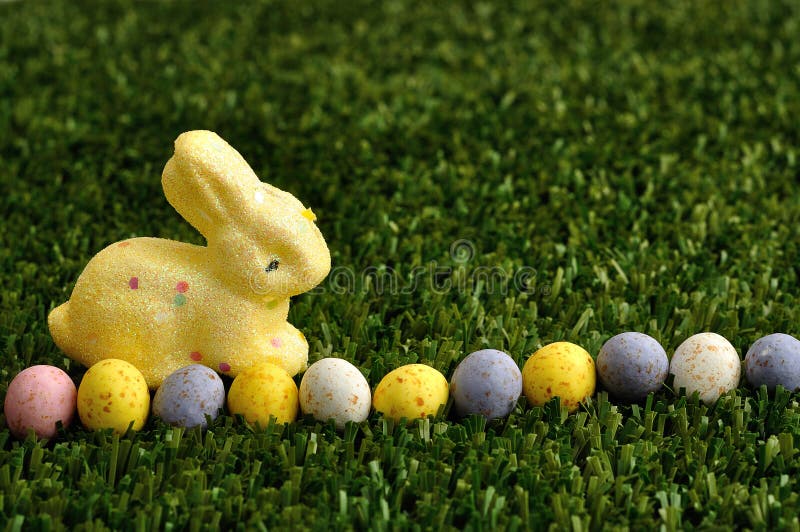 A Yellow Bunny with a Row of Speckled Easter Eggs Stock Image - Image ...