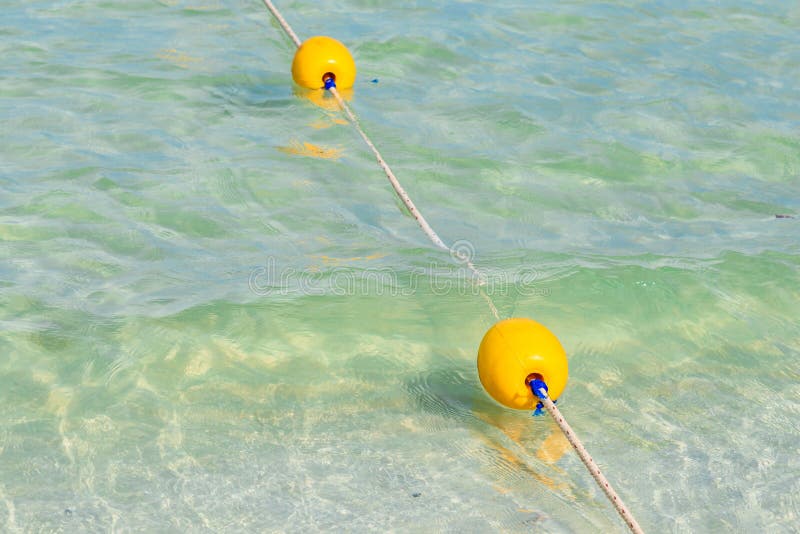 Yellow buoy in the sea. stock photo. Image of hawser - 92287328