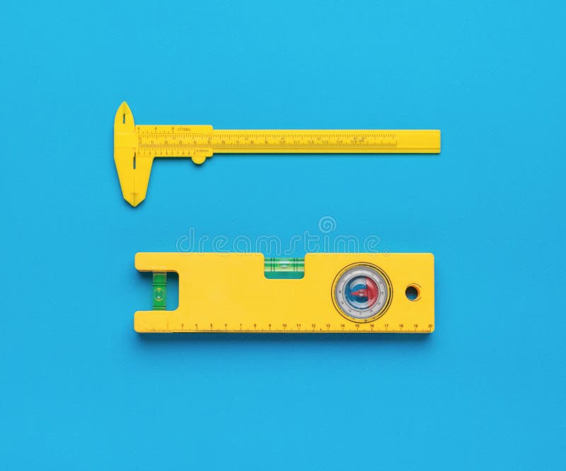 Yellow Caliper and Yellow Construction Level on a Bright Blue ...
