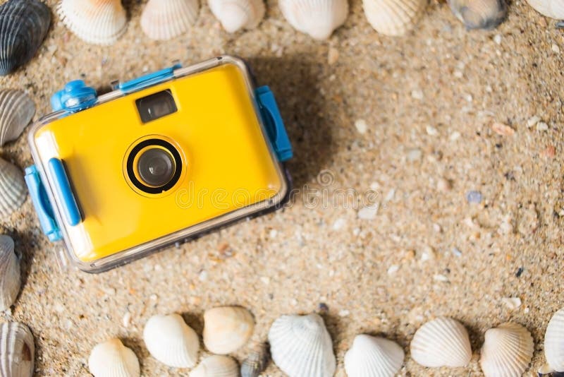 Yellow Camera Lying on Sand at the Beach Stock Photo - Image of shore ...